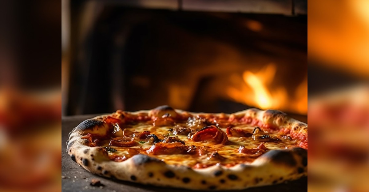 Pepperoni Pizza on a pizza stone in front of a fire 42