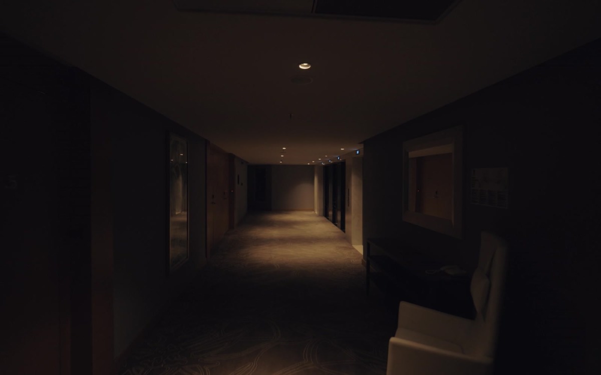 Walking in hotel hallway, view in dim light buildings - Stock Video